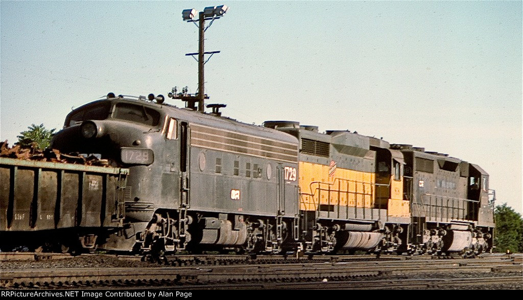 CR SD-35 6038 leads leased CNW GP-30 818 and F-7A 1729